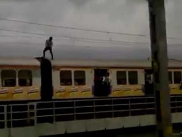 Video: Man performs life-threatening stunt atop Mumbai local train ...