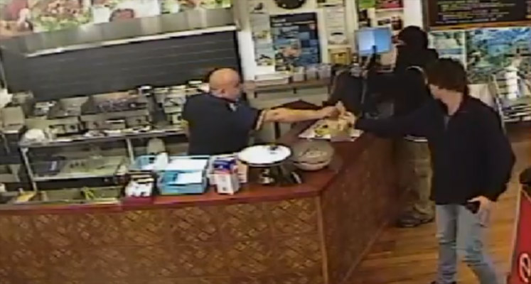 Watch the bravest shopkeeper in the world keep his cool with death ...